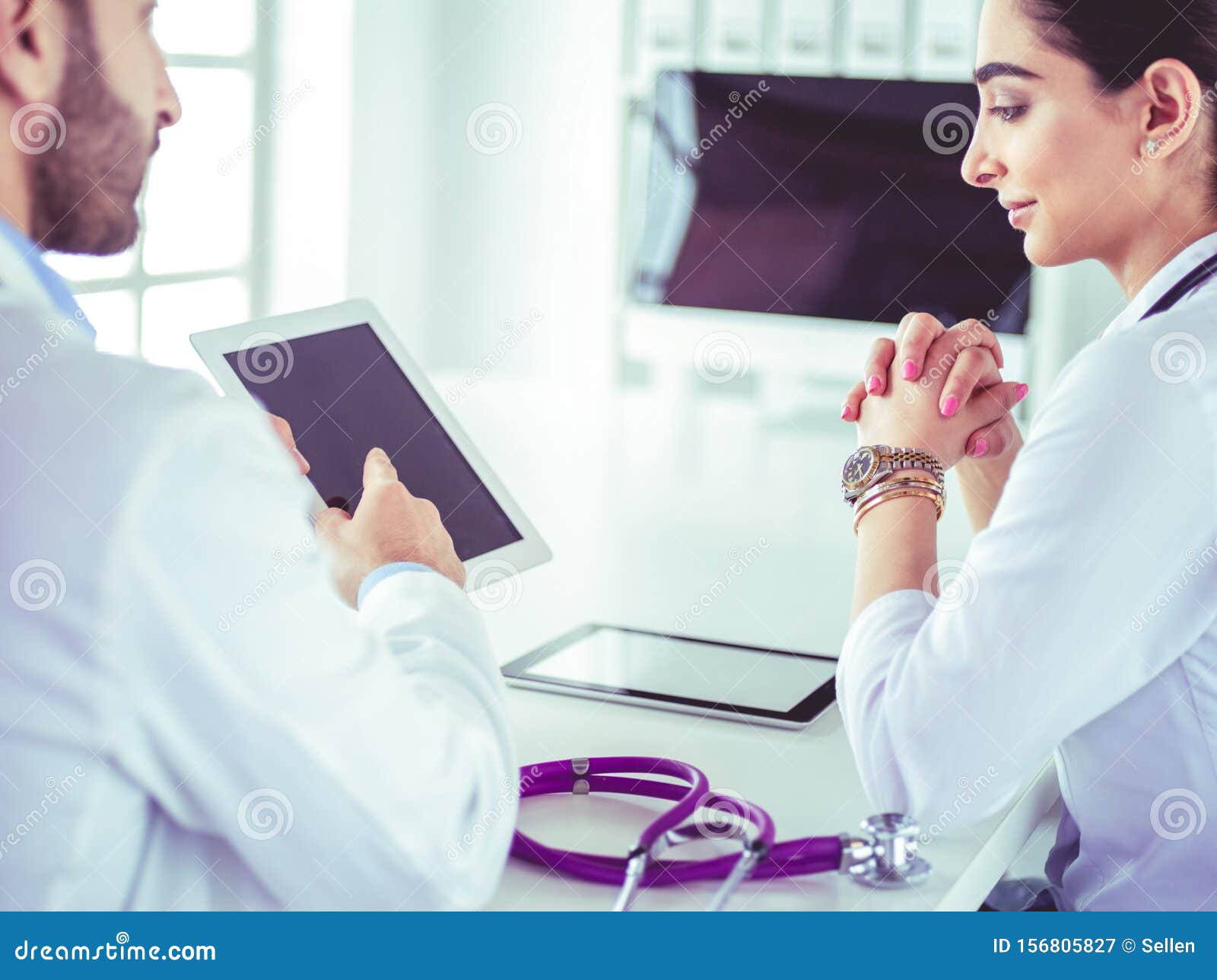 Team of Doctors Sitting at Table in Clinic Stock Image - Image of ...