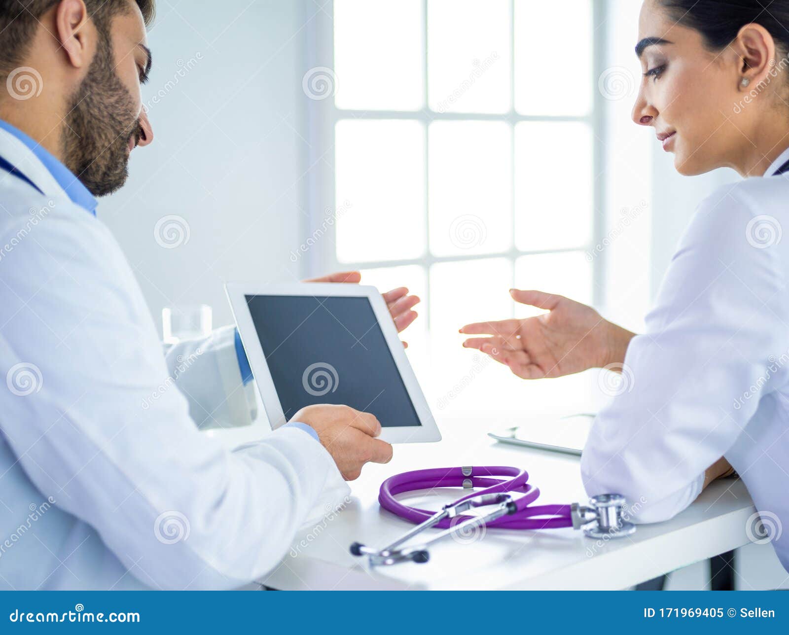 Team of Doctors Sitting at Table in Clinic Stock Image - Image of ...