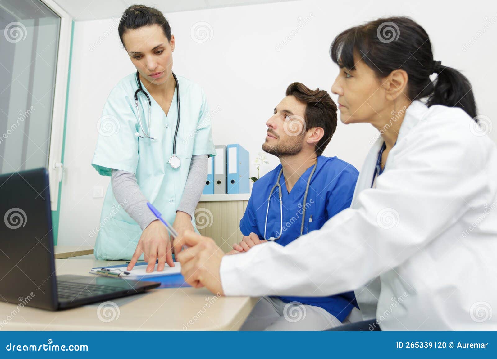 Team Doctors Sitting at Table in Row and Writing Stock Photo - Image of ...