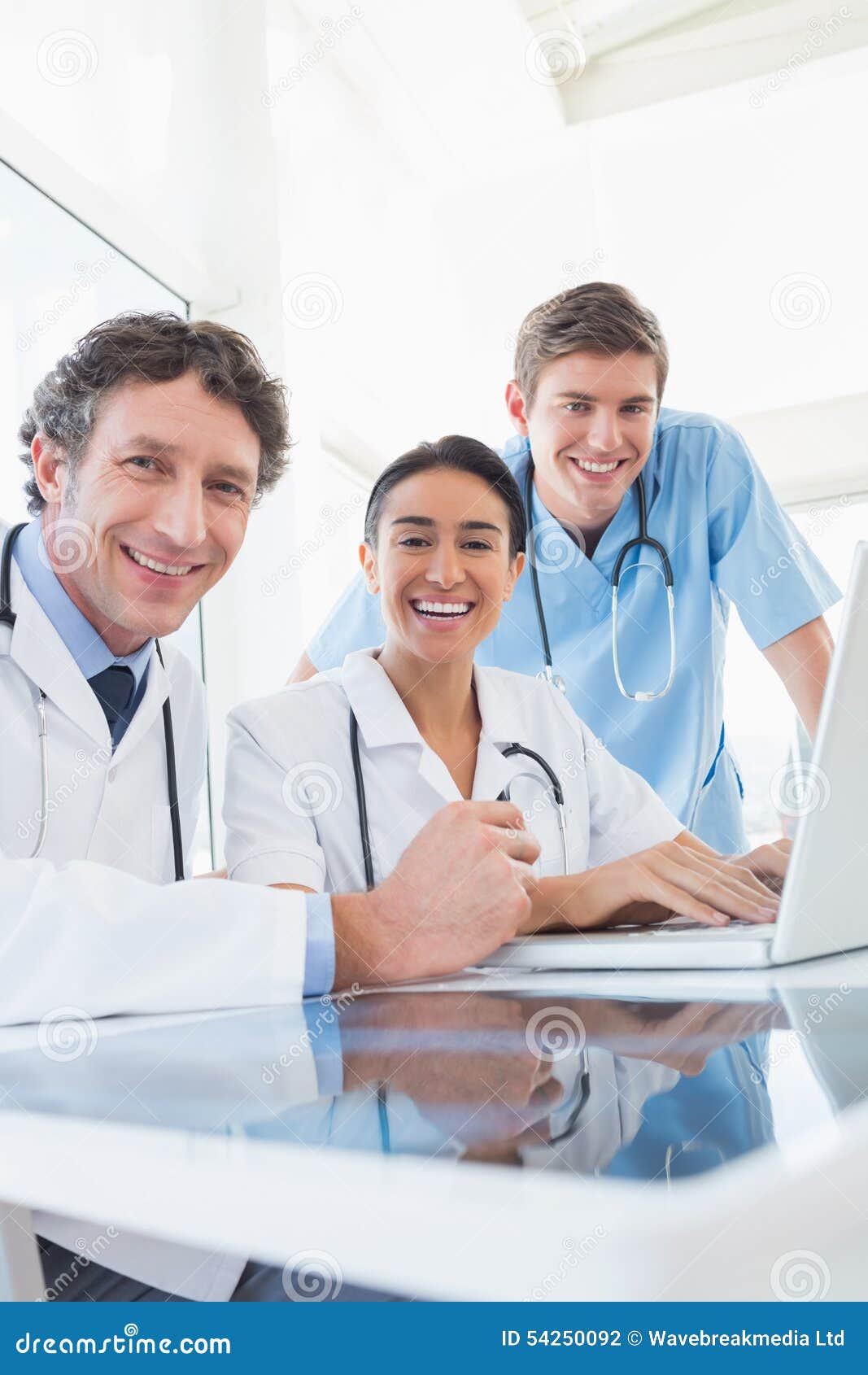 Team of Doctors Smiling at Camera Stock Photo - Image of coat, notebook ...