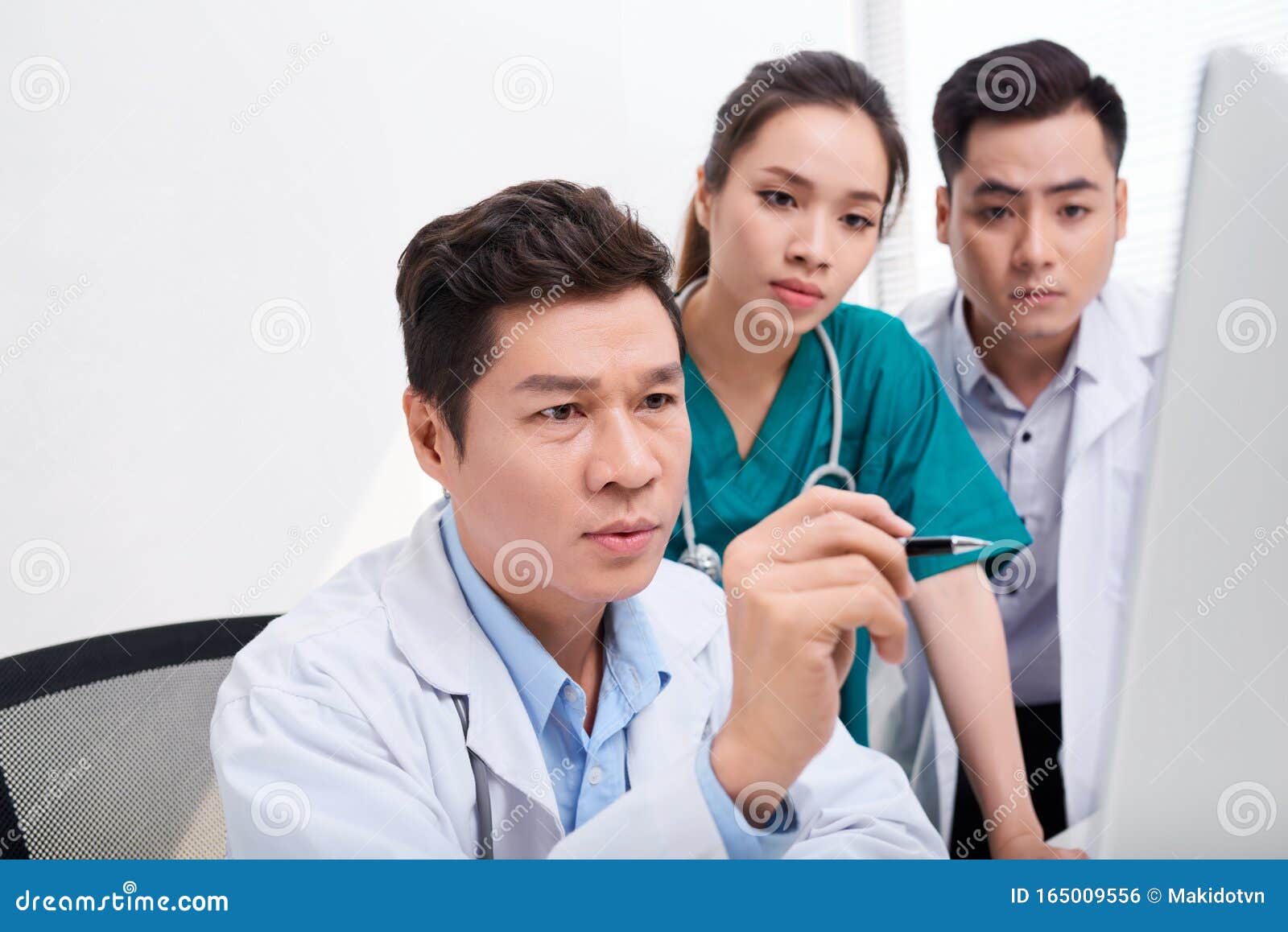 Team of Doctors Working and Having on Laptop in Medical Office Stock ...