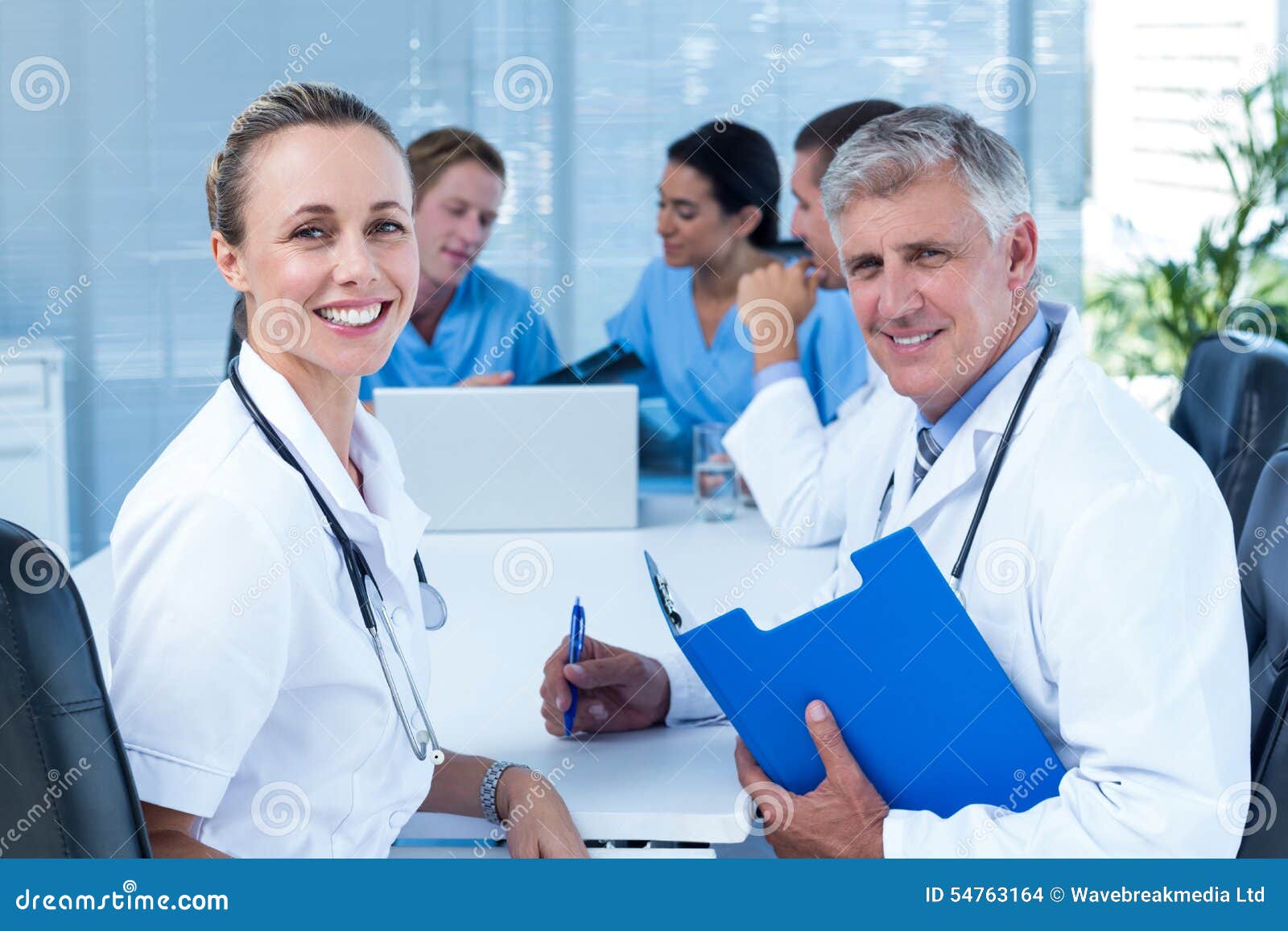 Team of Doctors Working on Their Files Stock Photo - Image of computer ...