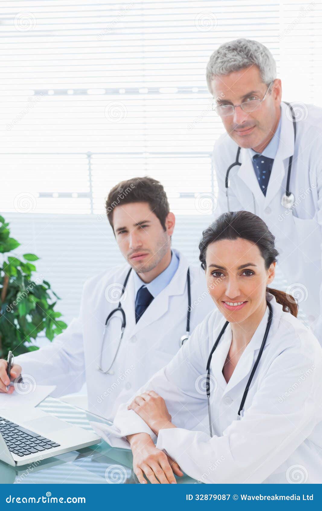 Team of Doctors Working Together Looking at Camera Stock Image - Image ...