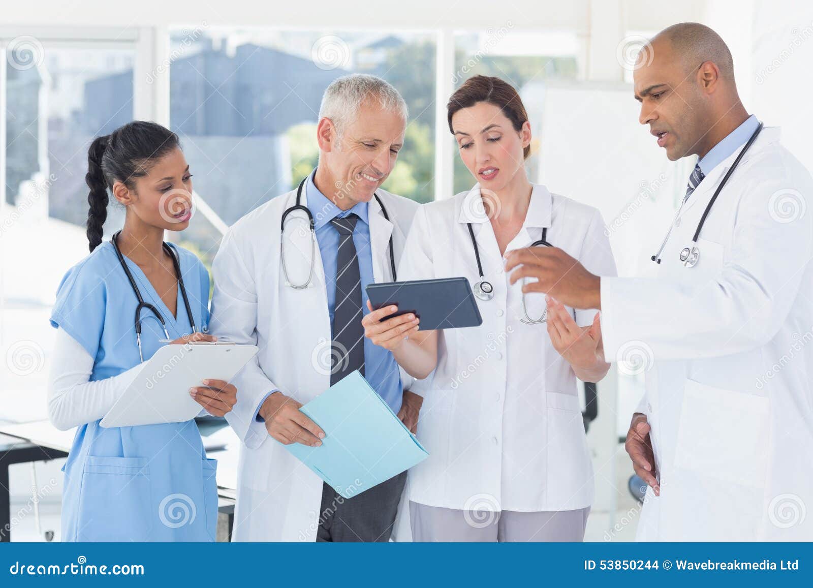 Team of Doctors Working Together on Patients File Stock Photo - Image ...