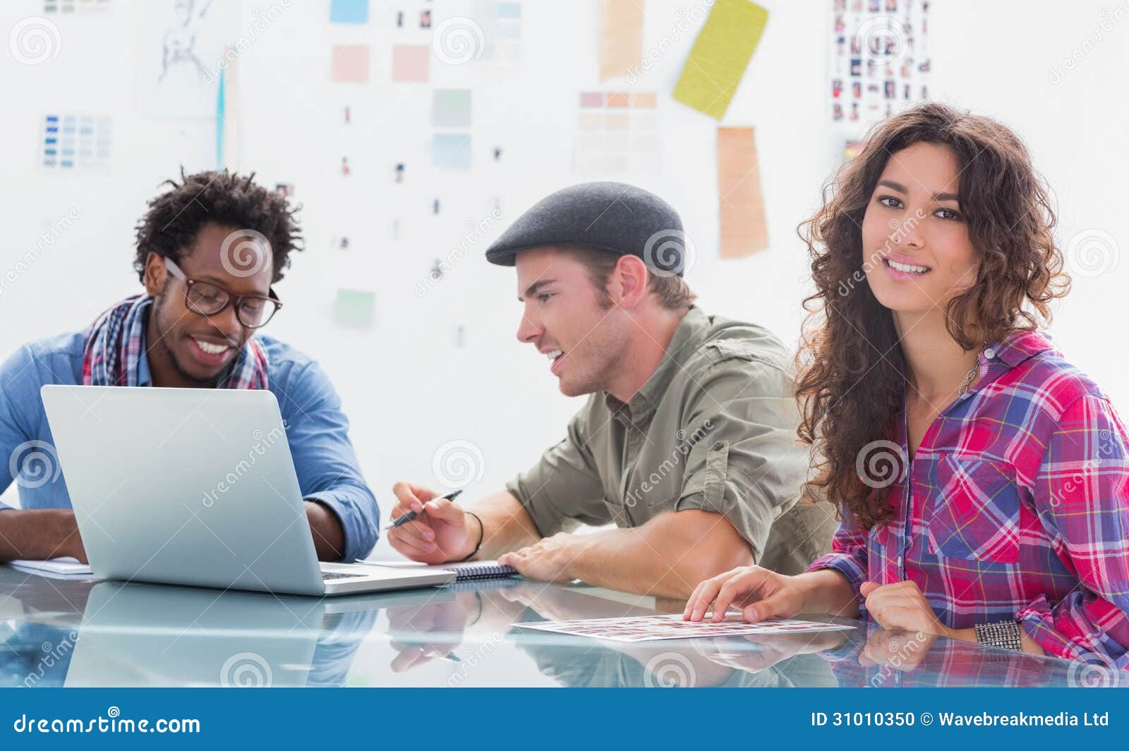 Team of Editors at Work with One Smiling at Camera Stock Photo - Image ...