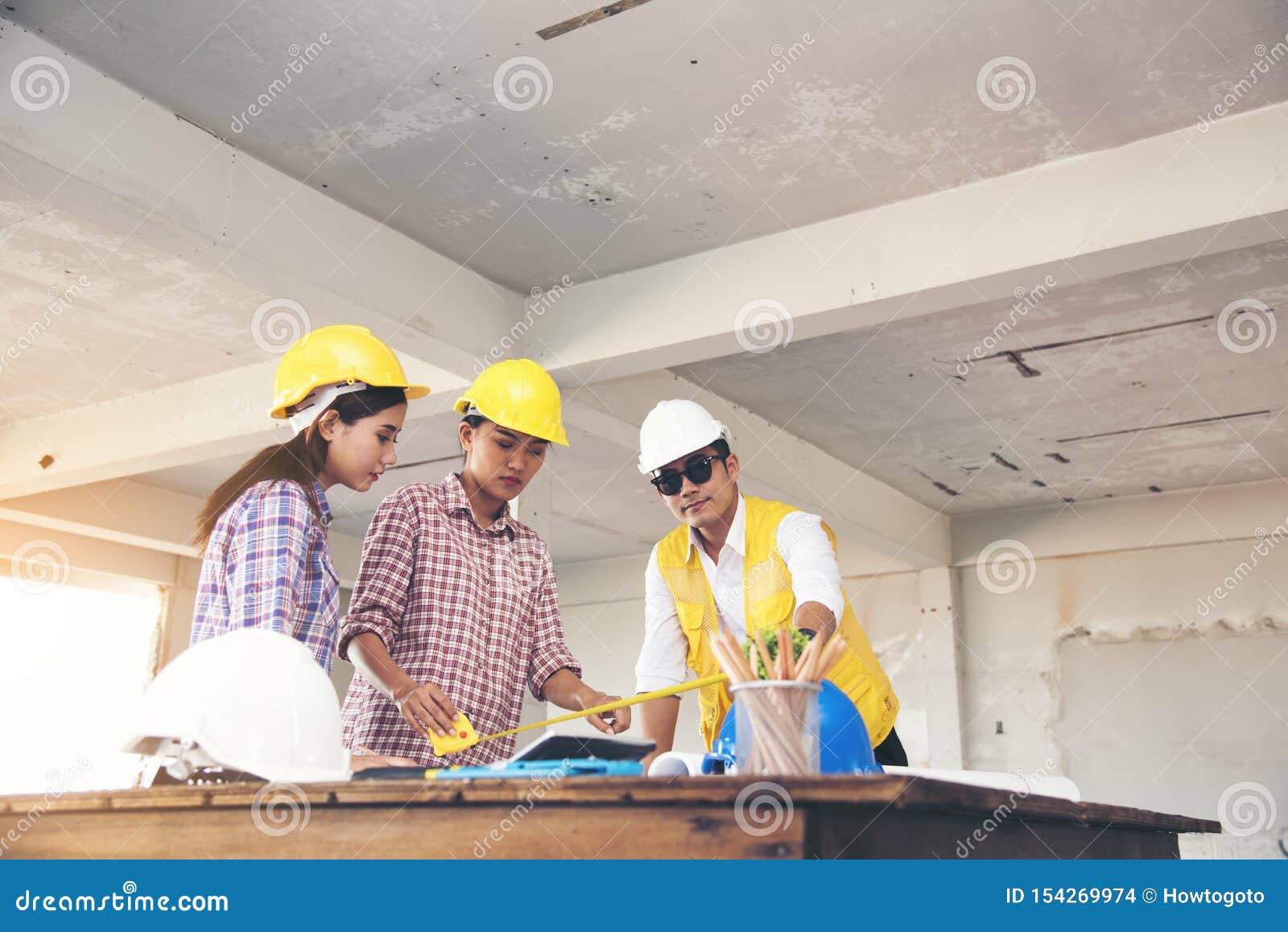 Asian Team Engineer Working in Construction Site. Construction Concept ...