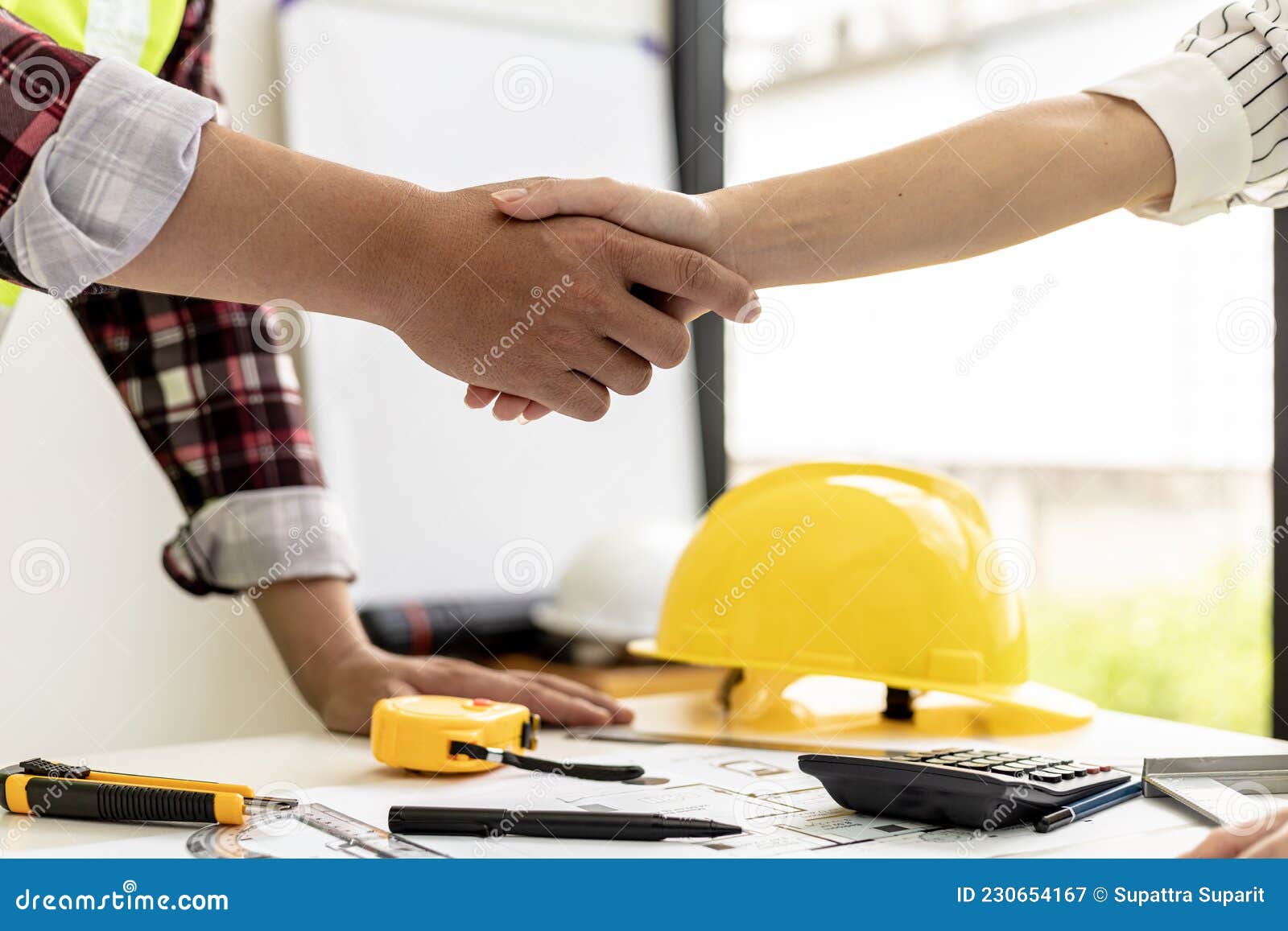 A Team of Engineers and Architects Shake Hands after Co-designing a ...