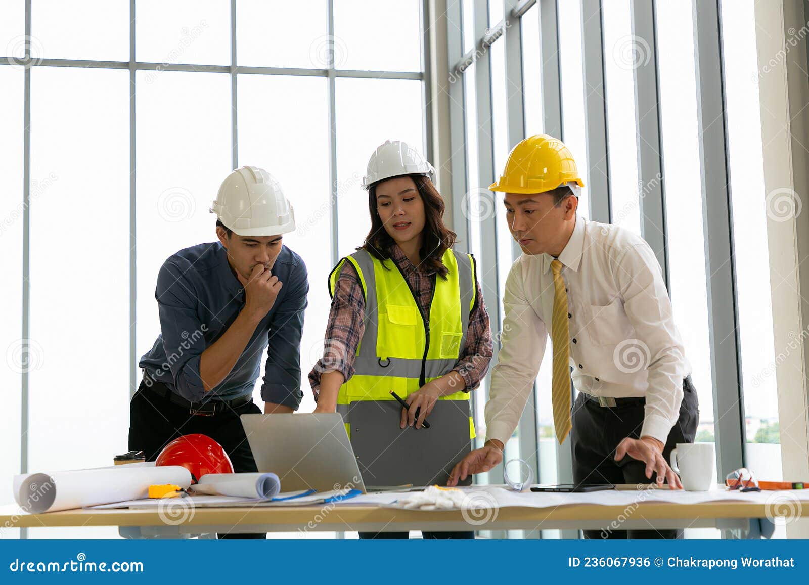 Team of Engineers Architects Working and Standing Around Table Working ...