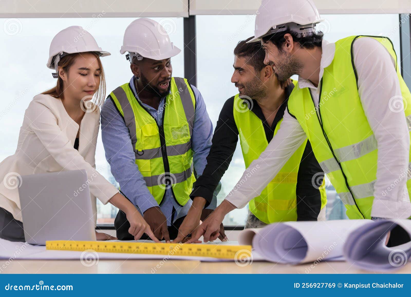 Team Engineers with Draft Plan of Building on Constructing Site ...