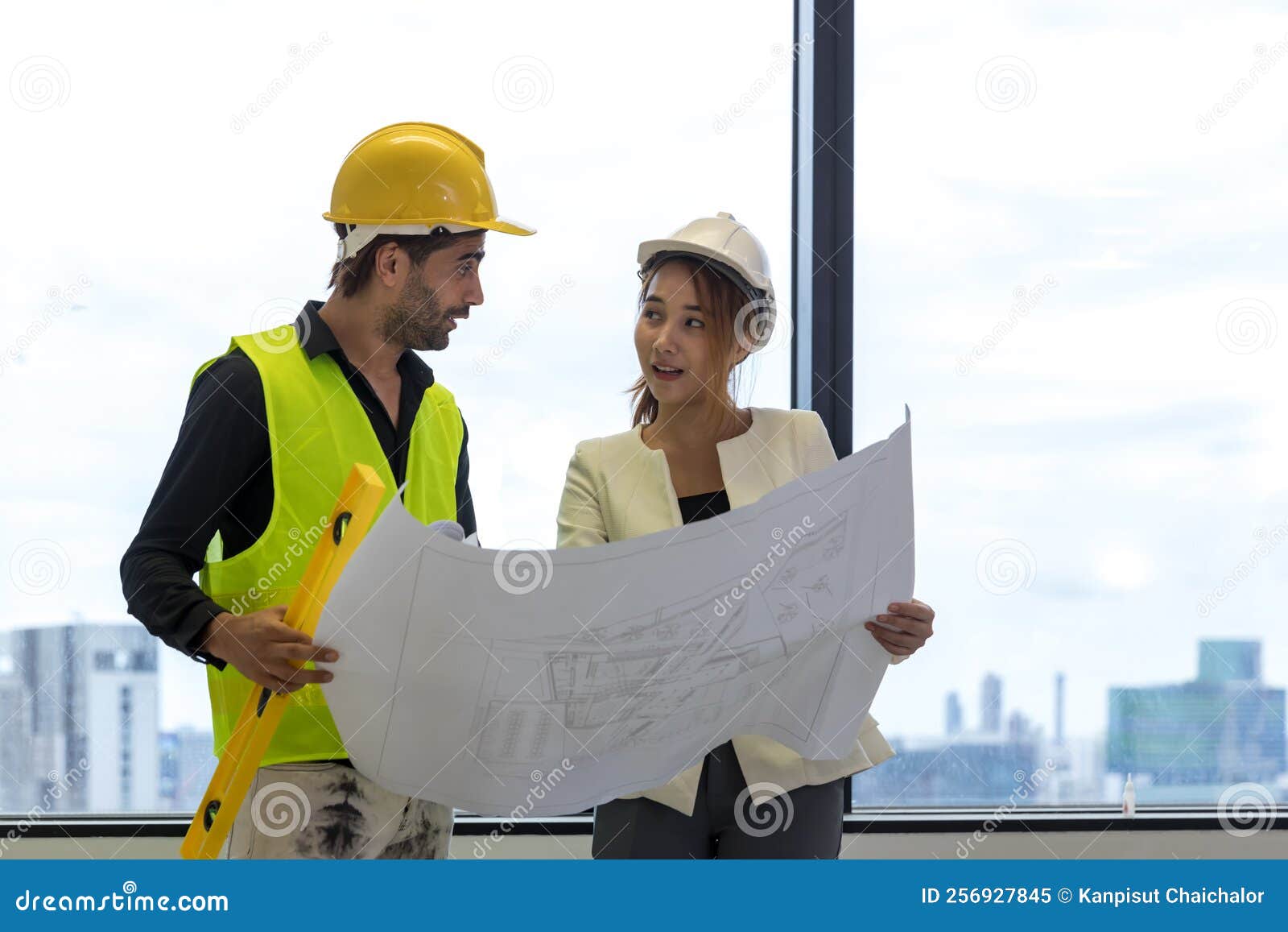 Team Engineers with Draft Plan of Building on Constructing Site. Stock ...