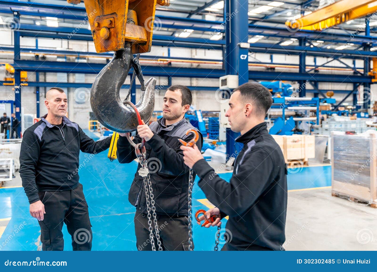 Teamwork Using an Industrial Cane in a Factory Stock Image - Image of ...