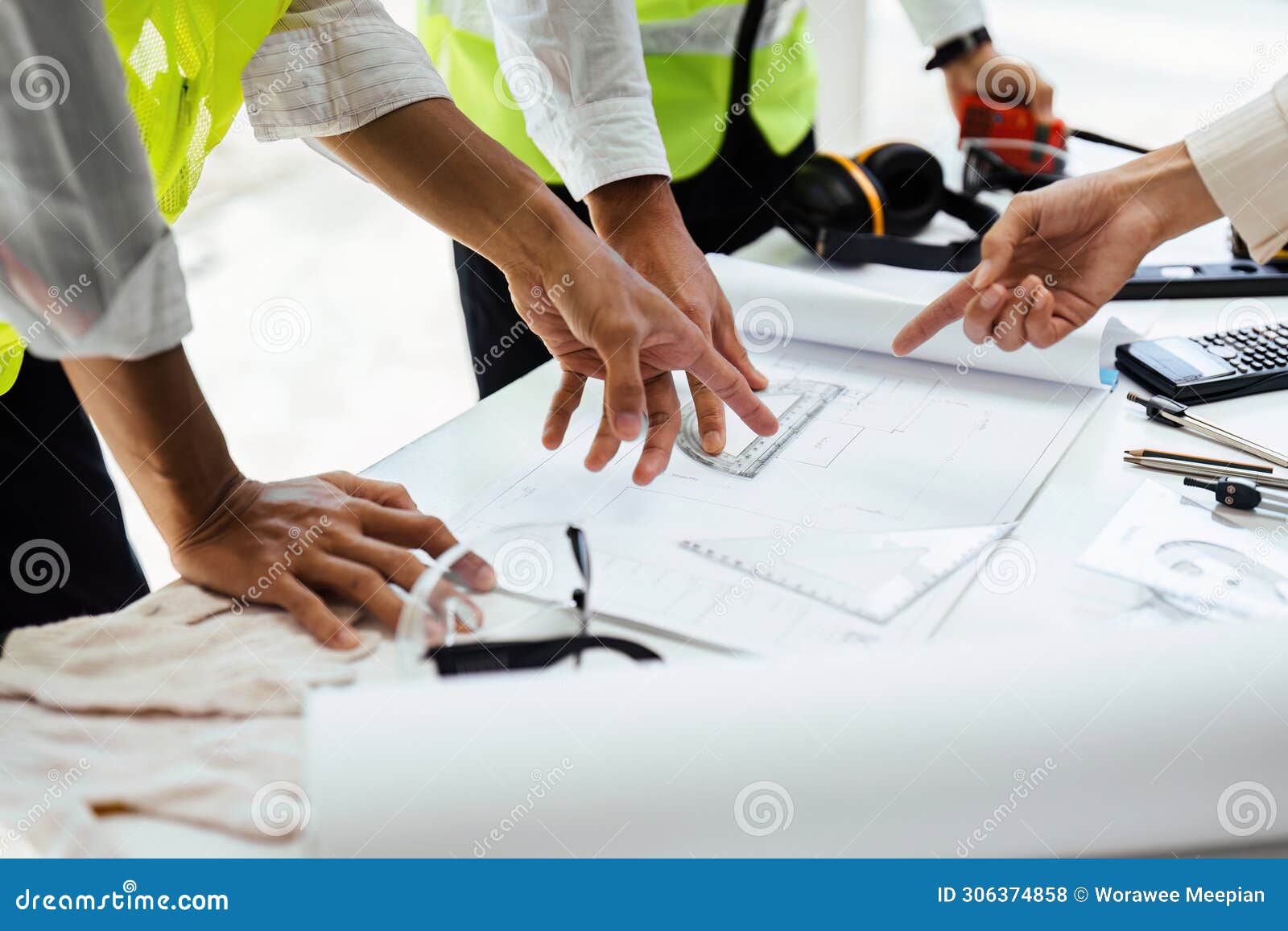 Team of Engineers Reviewing Blueprints Sketch of a New Construction ...