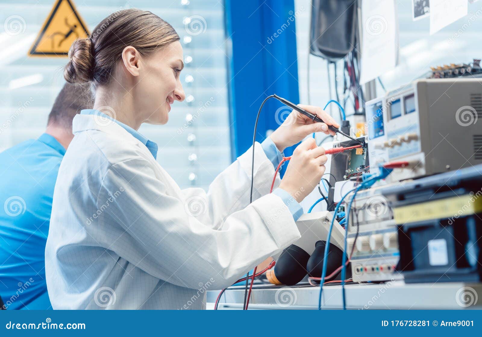 Team of Engineers Testing and Measuring an Electronic Product in the ...