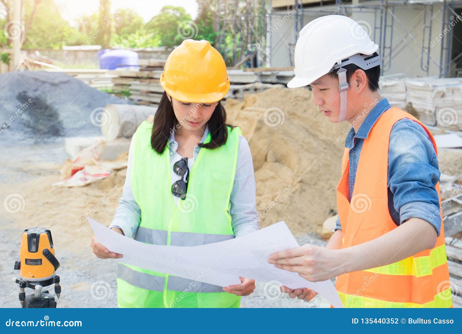 Team of Engineers Wearing Yellow Helmet and Working at Construction ...