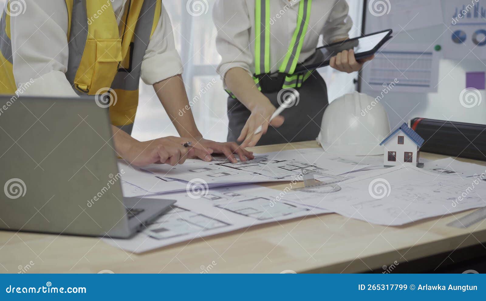 Team of Engineers Working Together on Blueprint Plan at Construction ...