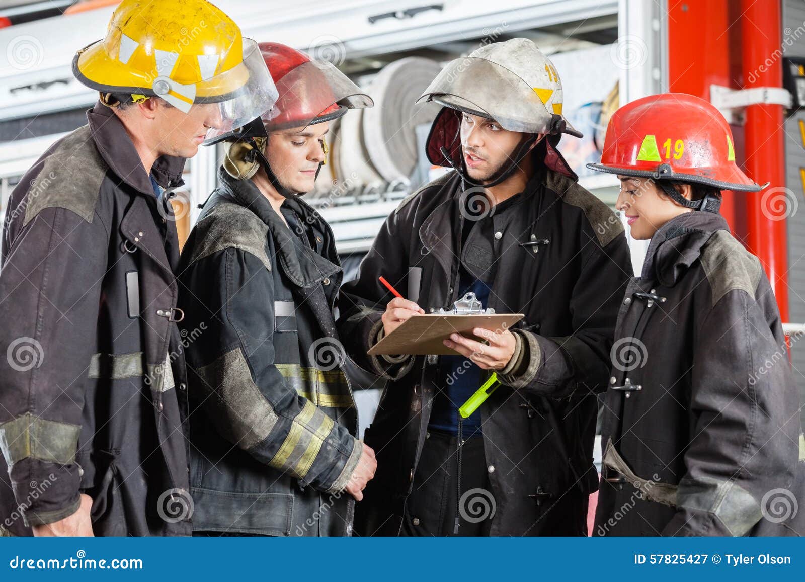 Team of Firefighters Discussing Over Clipboard Stock Image - Image of ...