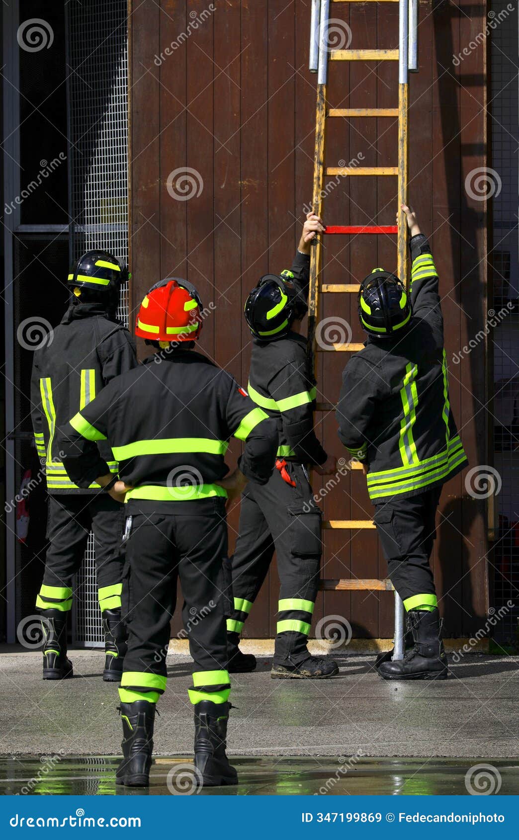 Team of Firefighters with Leader with Red Helmet during an Emergency ...