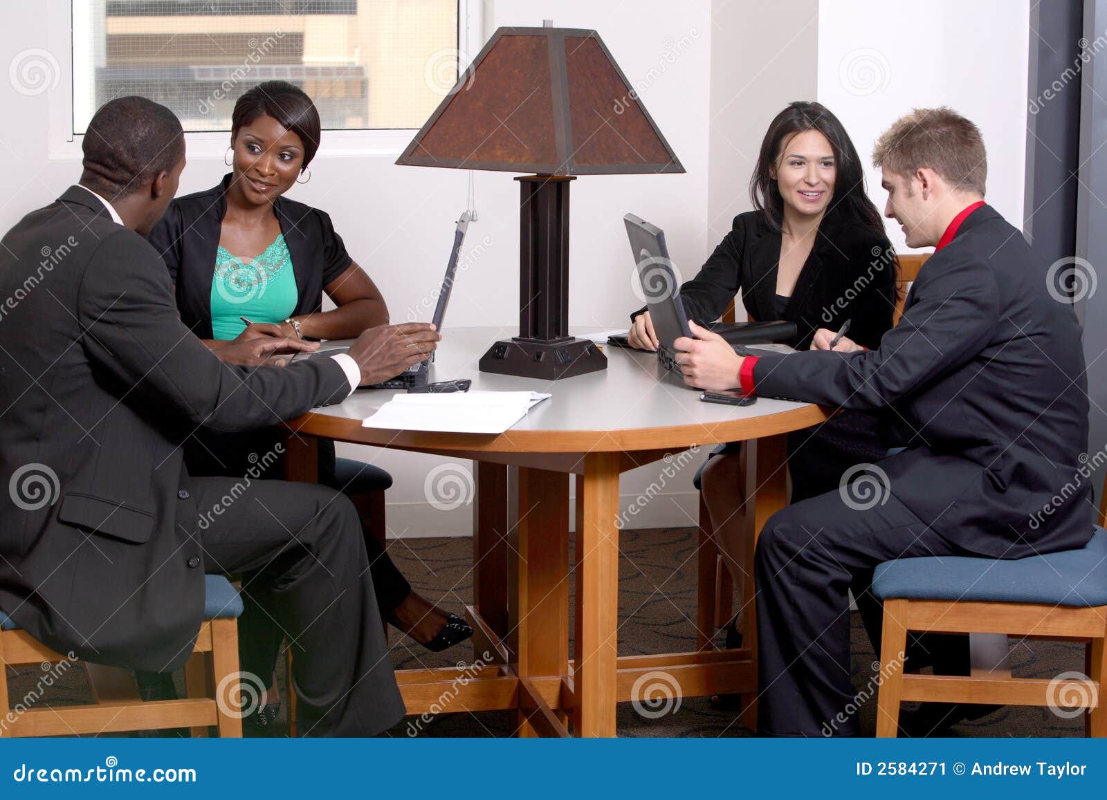 Team of Four Working at Table Stock Image - Image of portrait ...