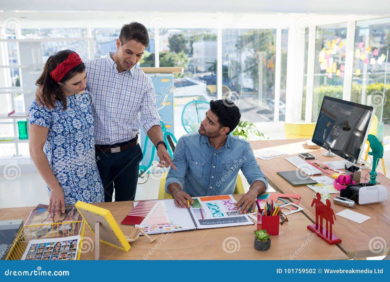Team of Graphic Designers Discussing Over Document Stock Photo - Image ...