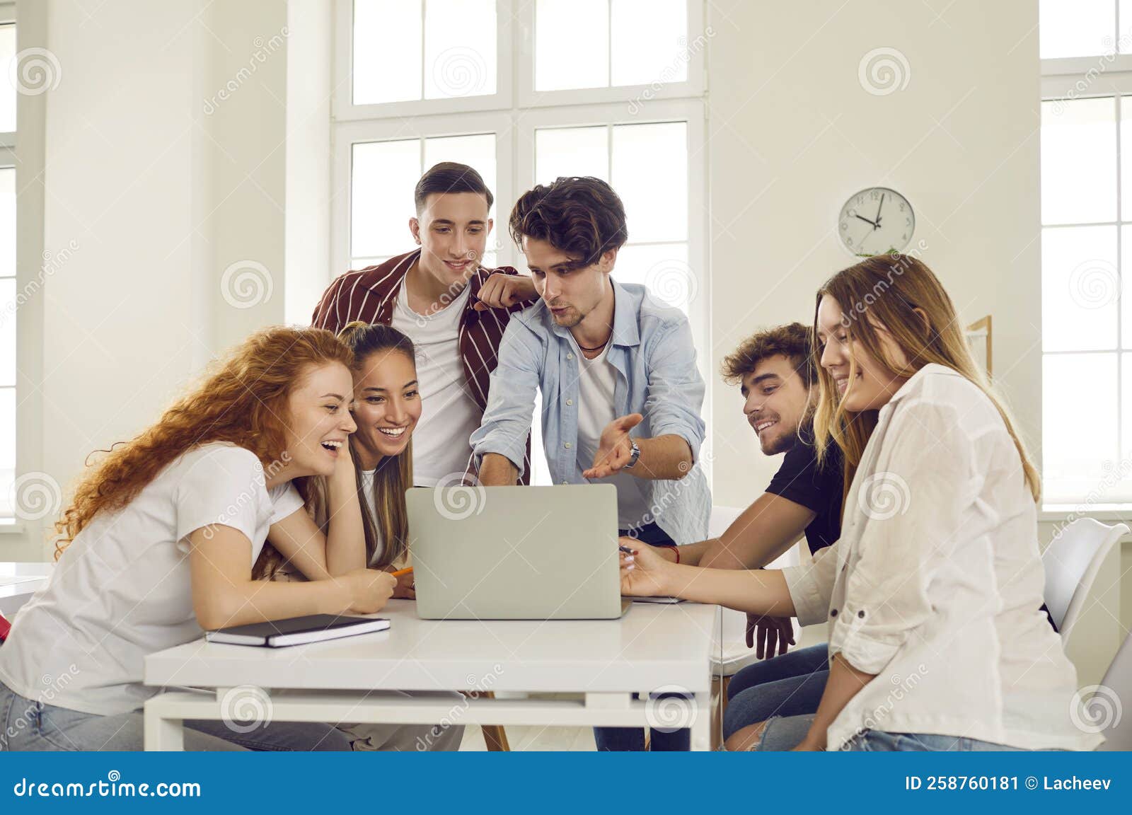 Team of Happy University Students Having Fun while Using Laptop for ...