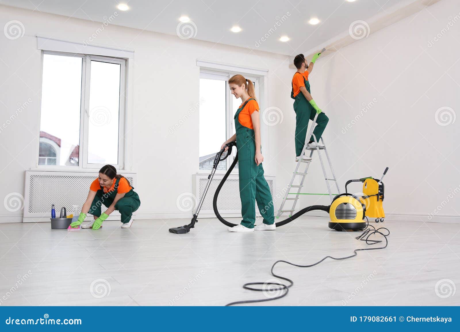 Team of Janitors in Uniforms Cleaning Room Stock Image - Image of ...