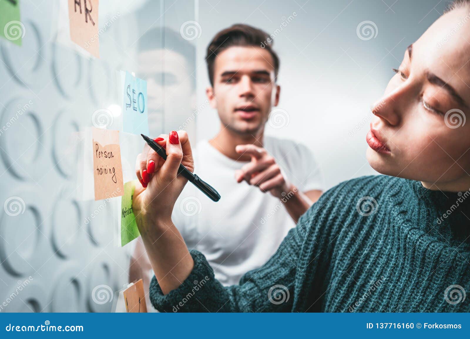Team of Male and Female Project Managers Discussing Ideas while ...