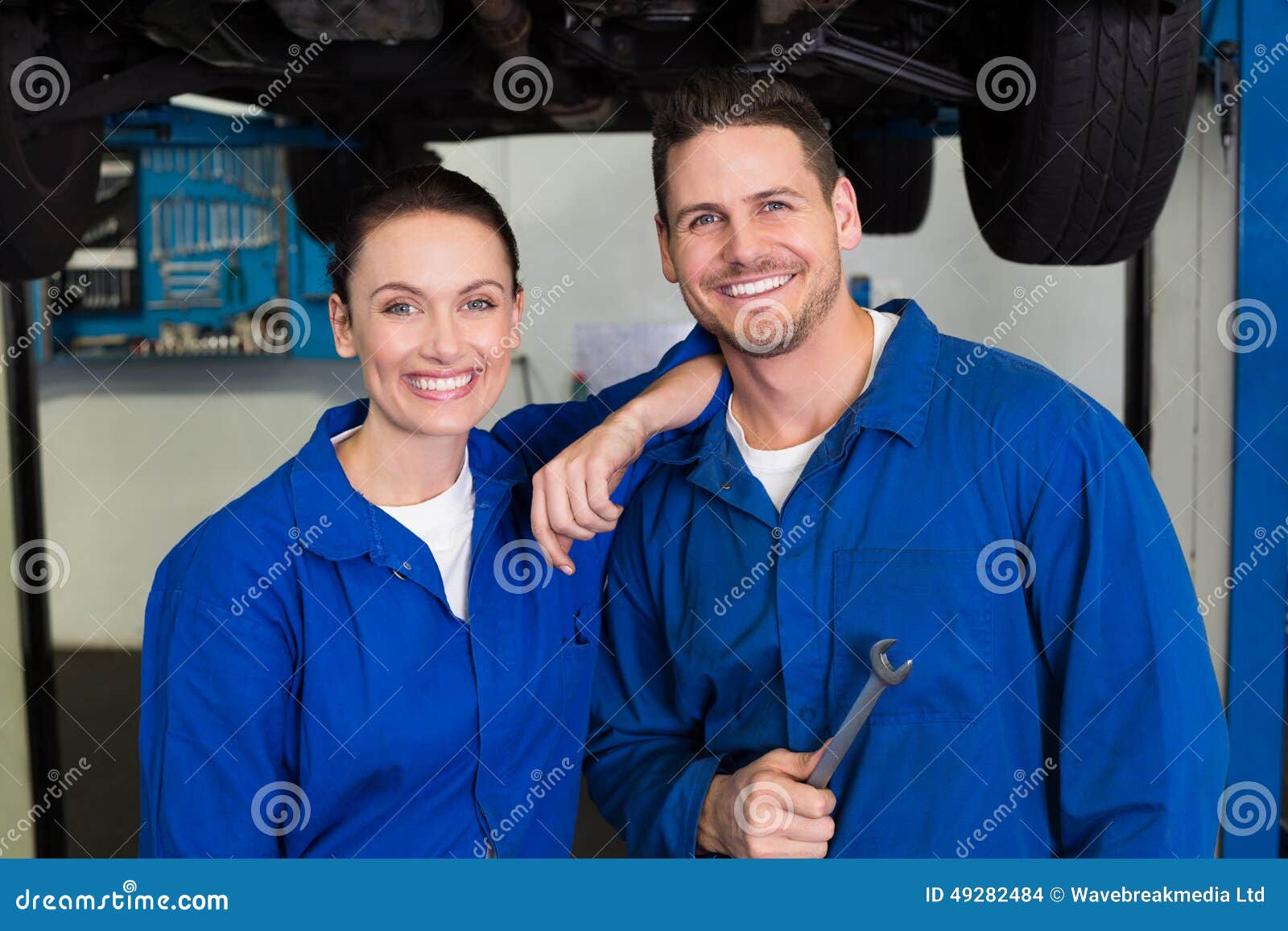 Team of Mechanics Smiling at Camera Stock Photo - Image of coveralls ...