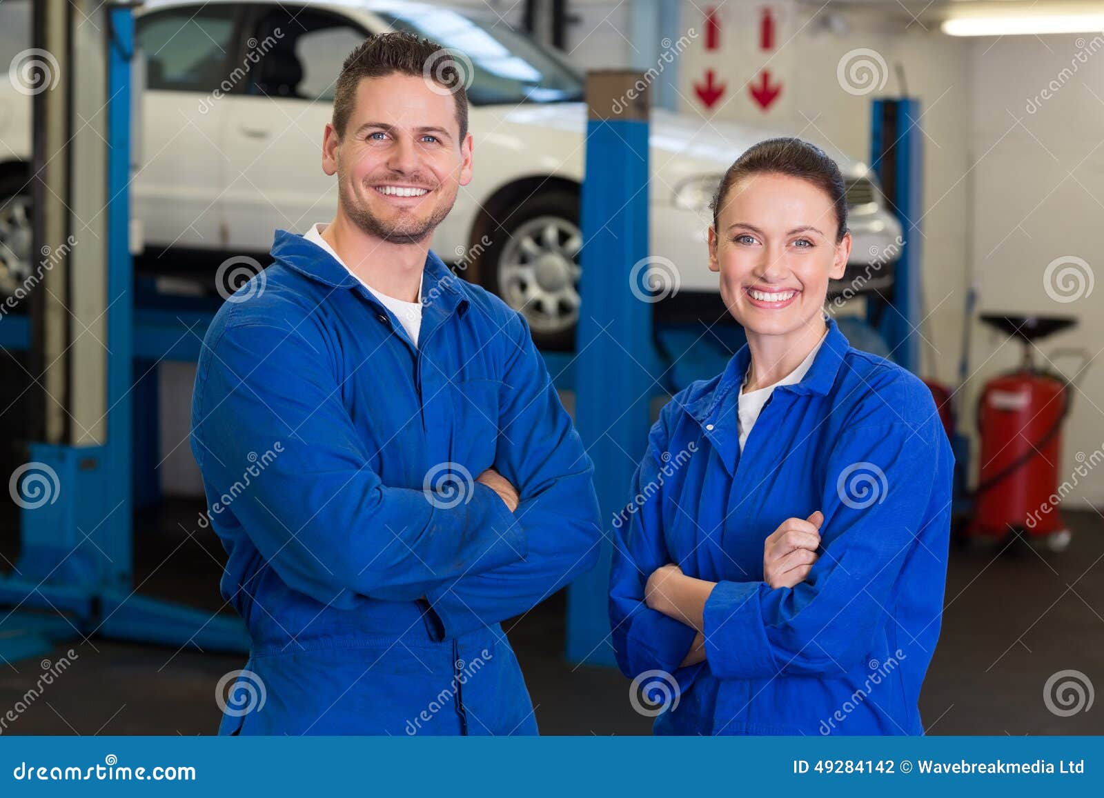 Team of Mechanics Smiling at Camera Stock Photo - Image of coveralls ...