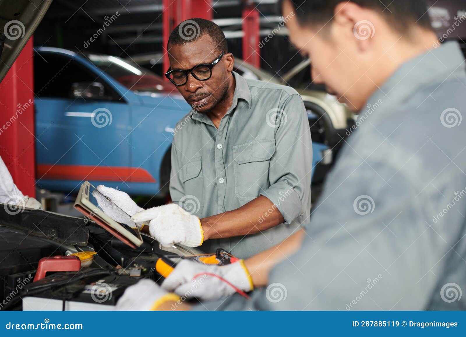 Team of Mechanics Using Multimeter Stock Image - Image of uniform ...