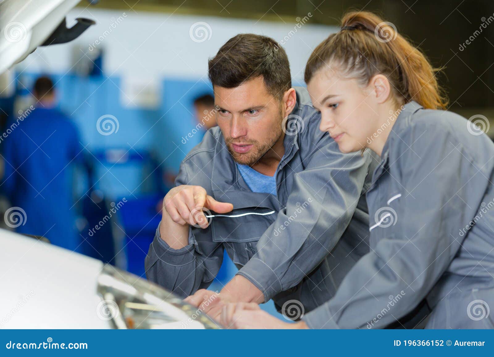 Team Mechanics Working at Garage Stock Photo - Image of woman, tablet ...