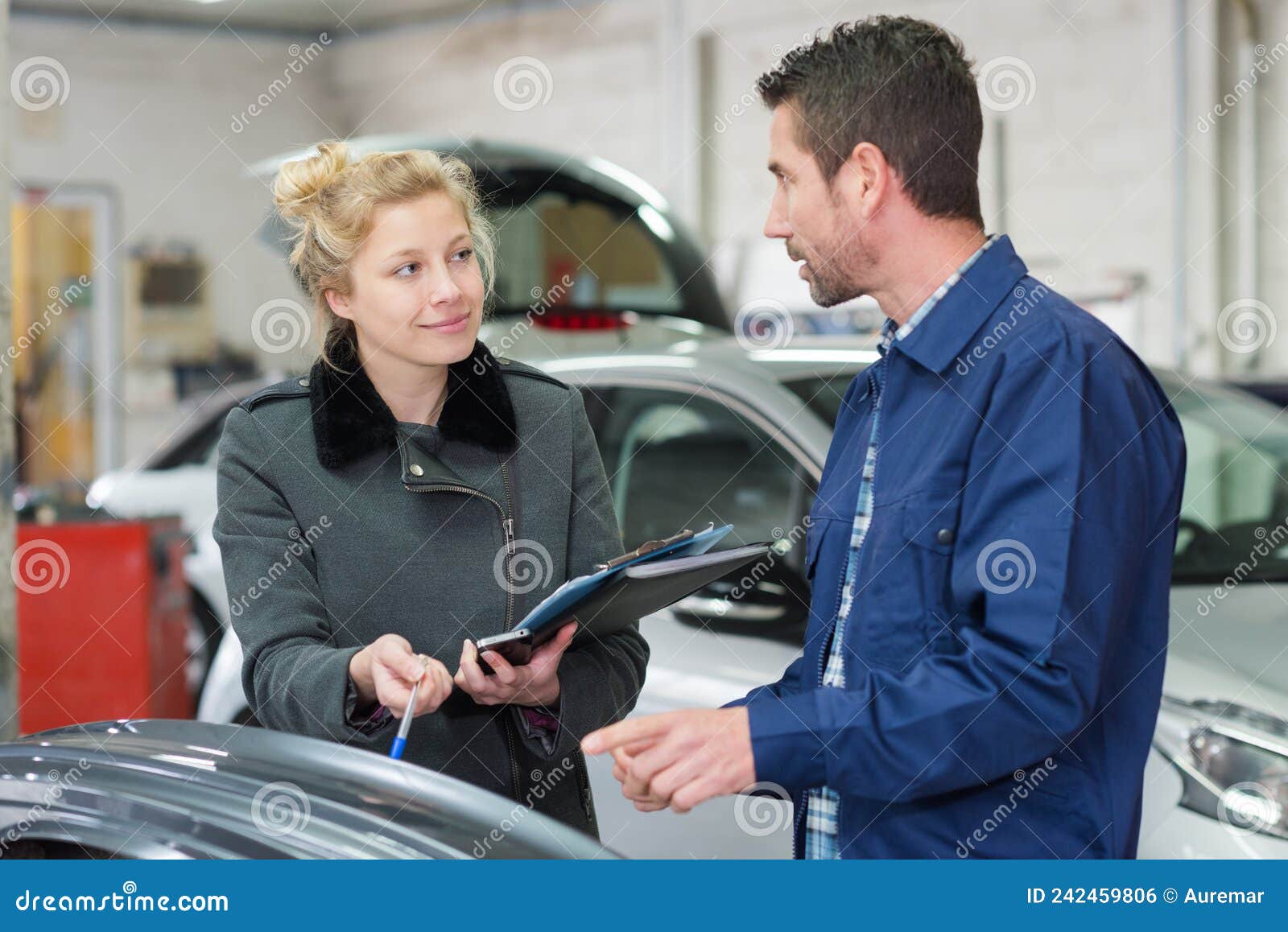 Team Mechanics Working at Garage Stock Photo - Image of woman, male ...