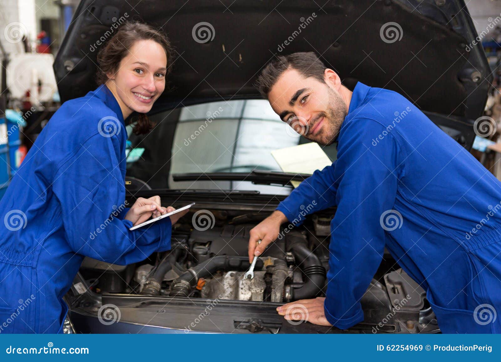 Team of Mechanics Working at the Garage Stock Image - Image of team ...