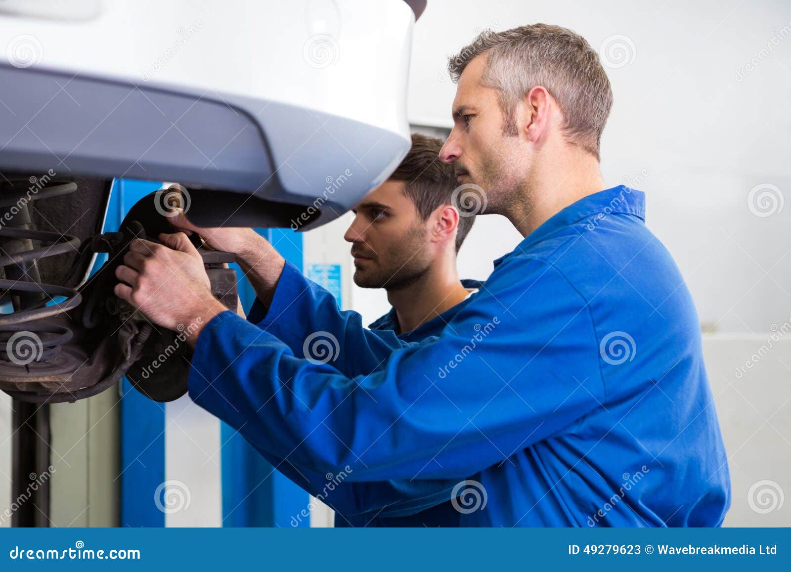 Team of Mechanics Working Together Stock Image - Image of automobile ...