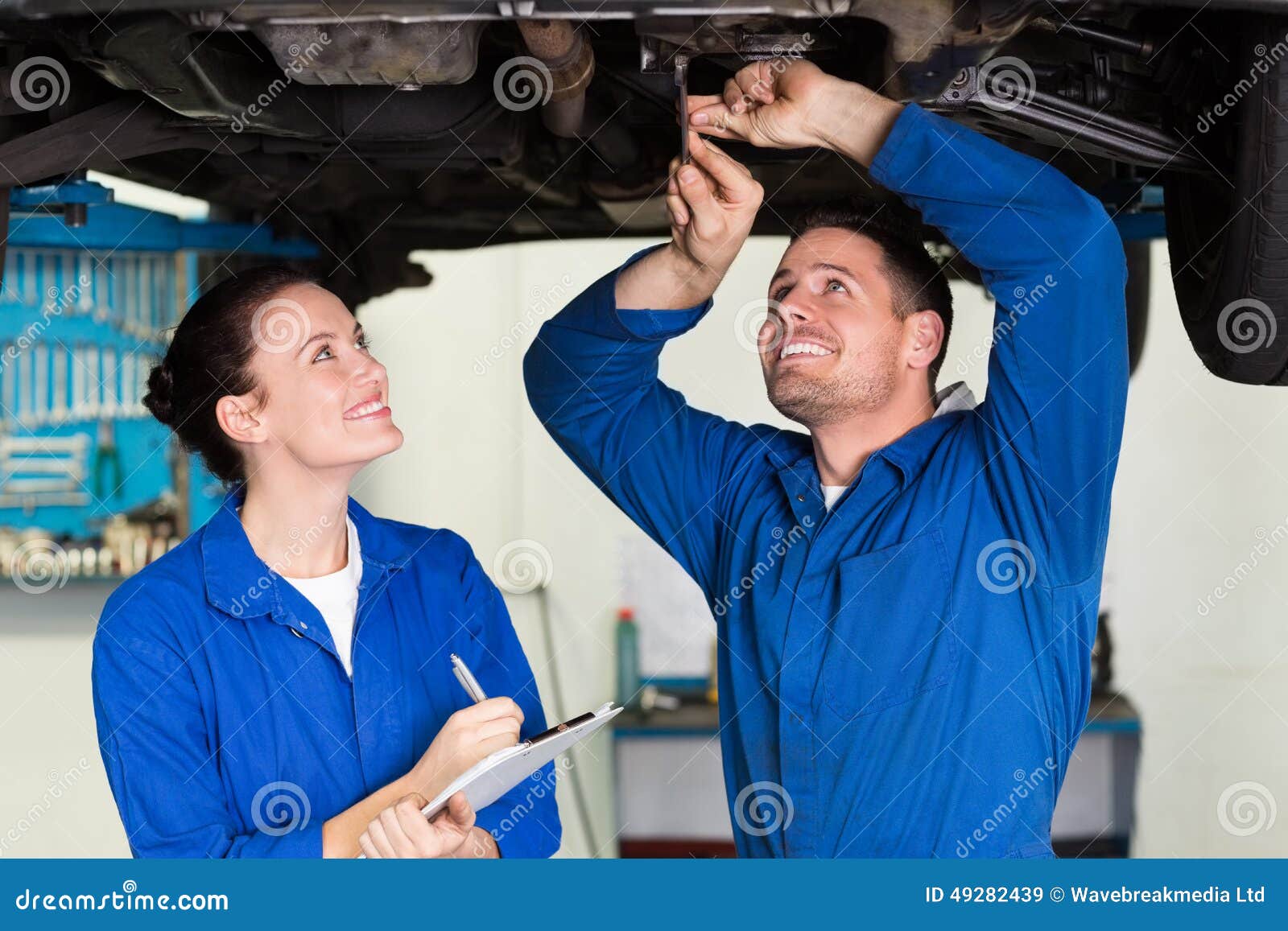 Team of Mechanics Working Together Stock Image - Image of happy, garage ...