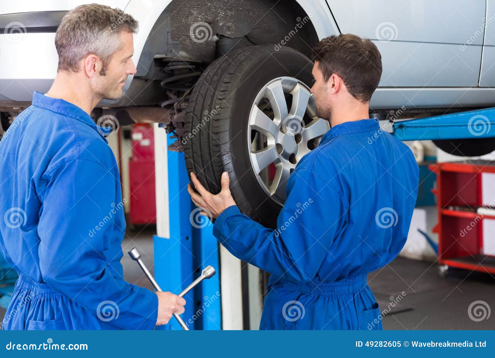 Team of Mechanics Working Together Stock Image - Image of coveralls ...