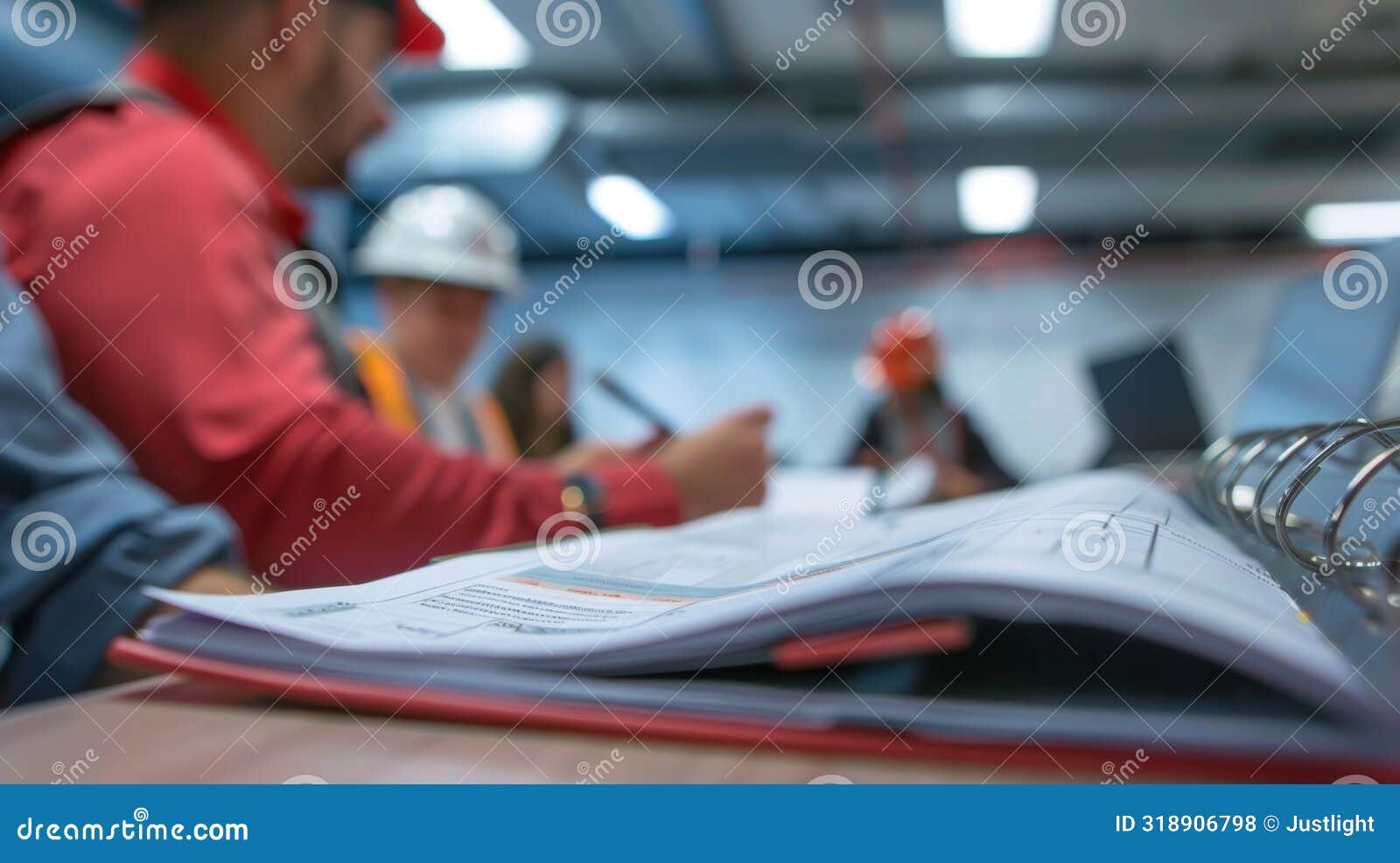 A Team Member Flips through a Thick Binder Referencing Safety ...