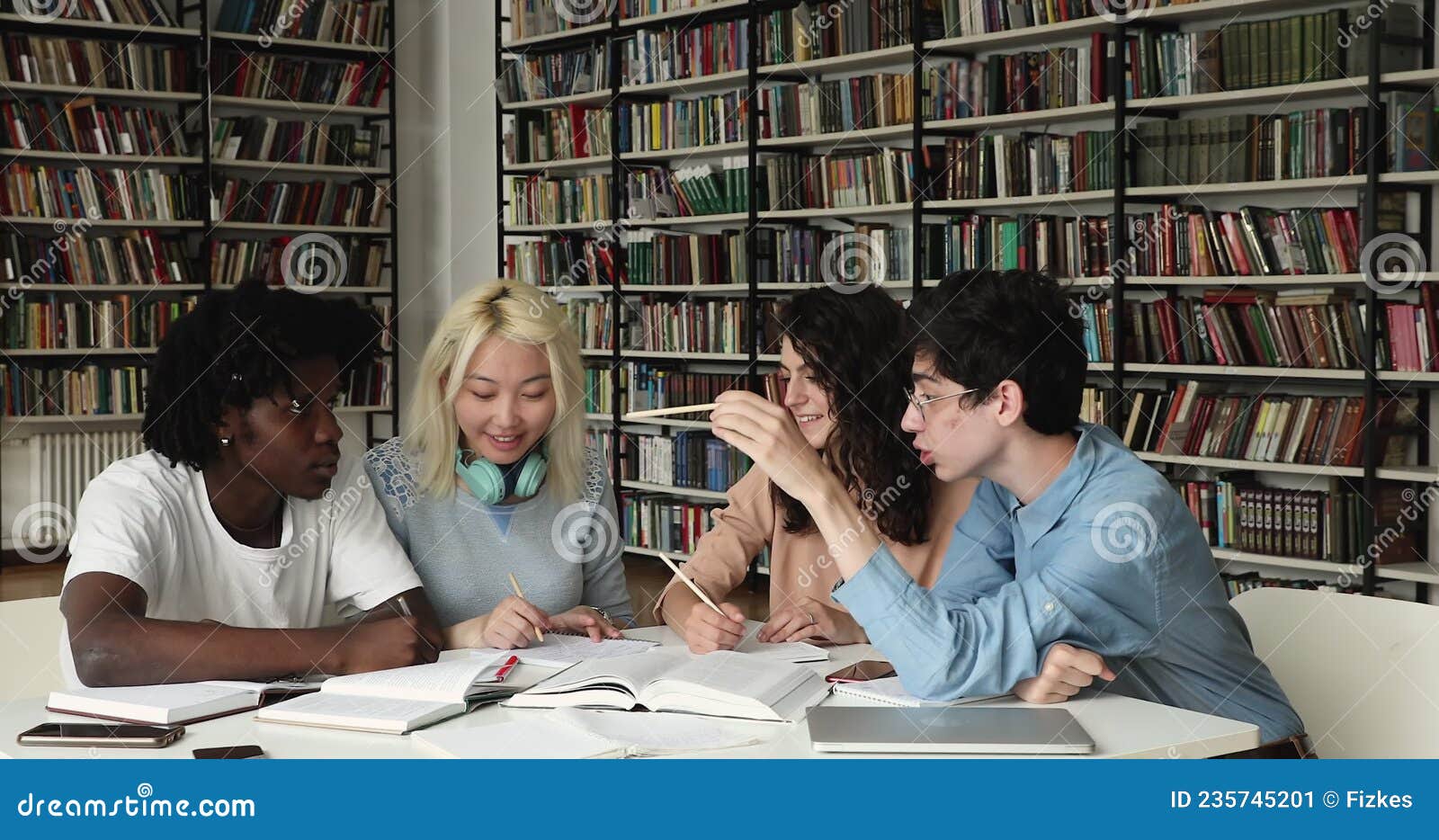 Team of Multiracial University Students Studying Together in Library ...
