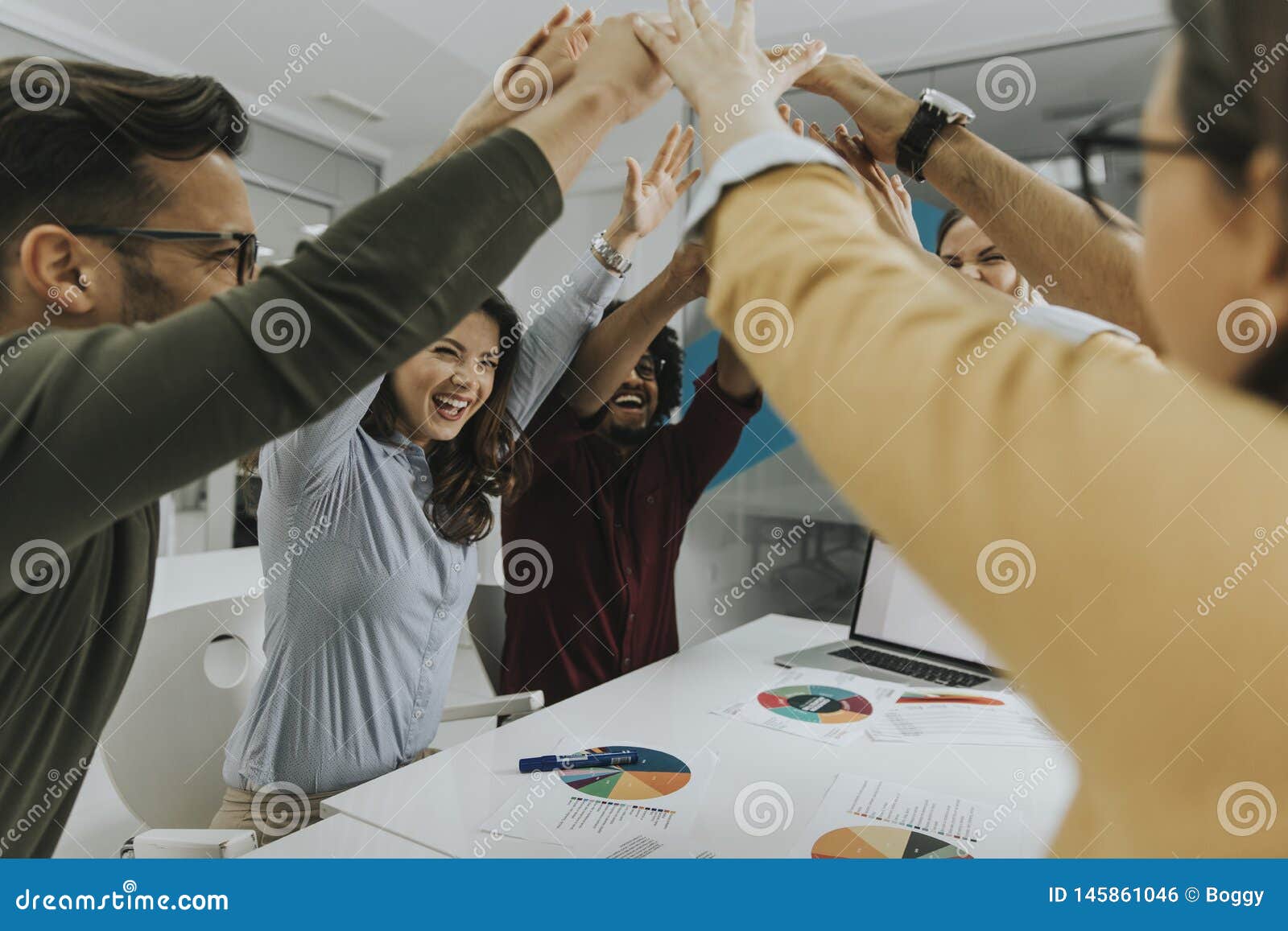 Team People Stacking Hands Together Over Table Engaged in Teambuilding ...