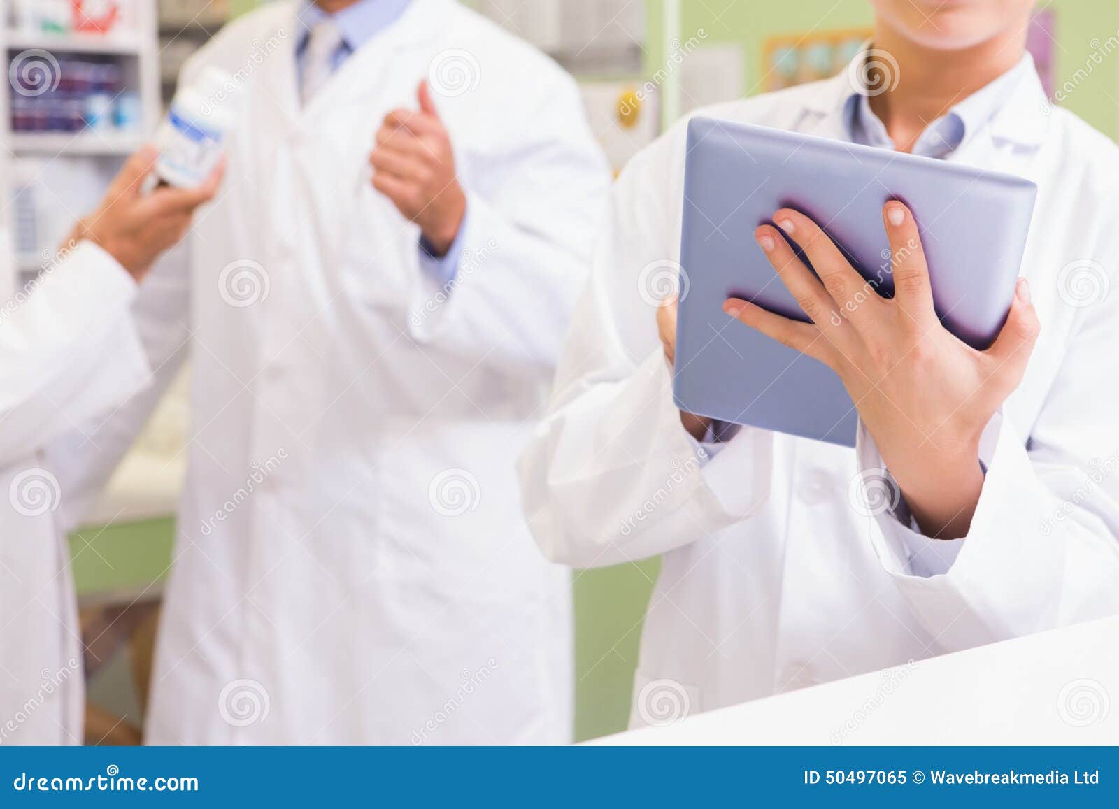 Team of Pharmacist Using Tablet and Holding Medication Stock Image ...