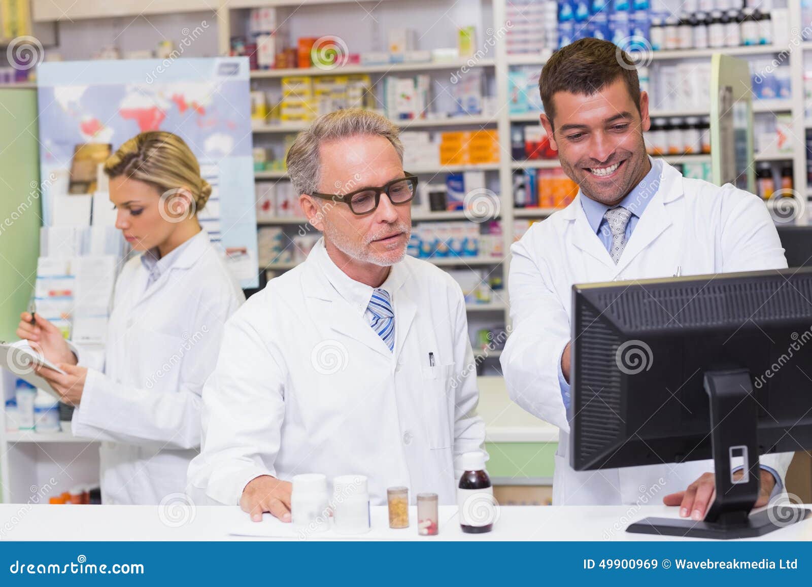 Team of Pharmacists Looking at Computer Stock Image - Image of clinic ...