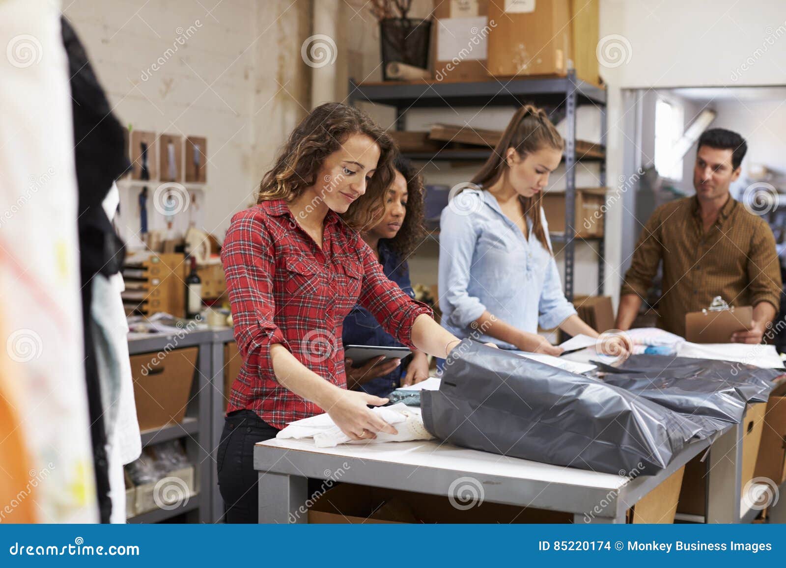 Team in a Post Room Packing Clothes Orders for Distribution Stock Photo ...