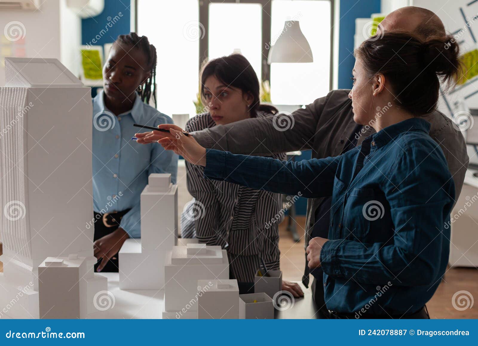 Team of Professional Architects Brainstorming Ideeas Pointing at Real ...