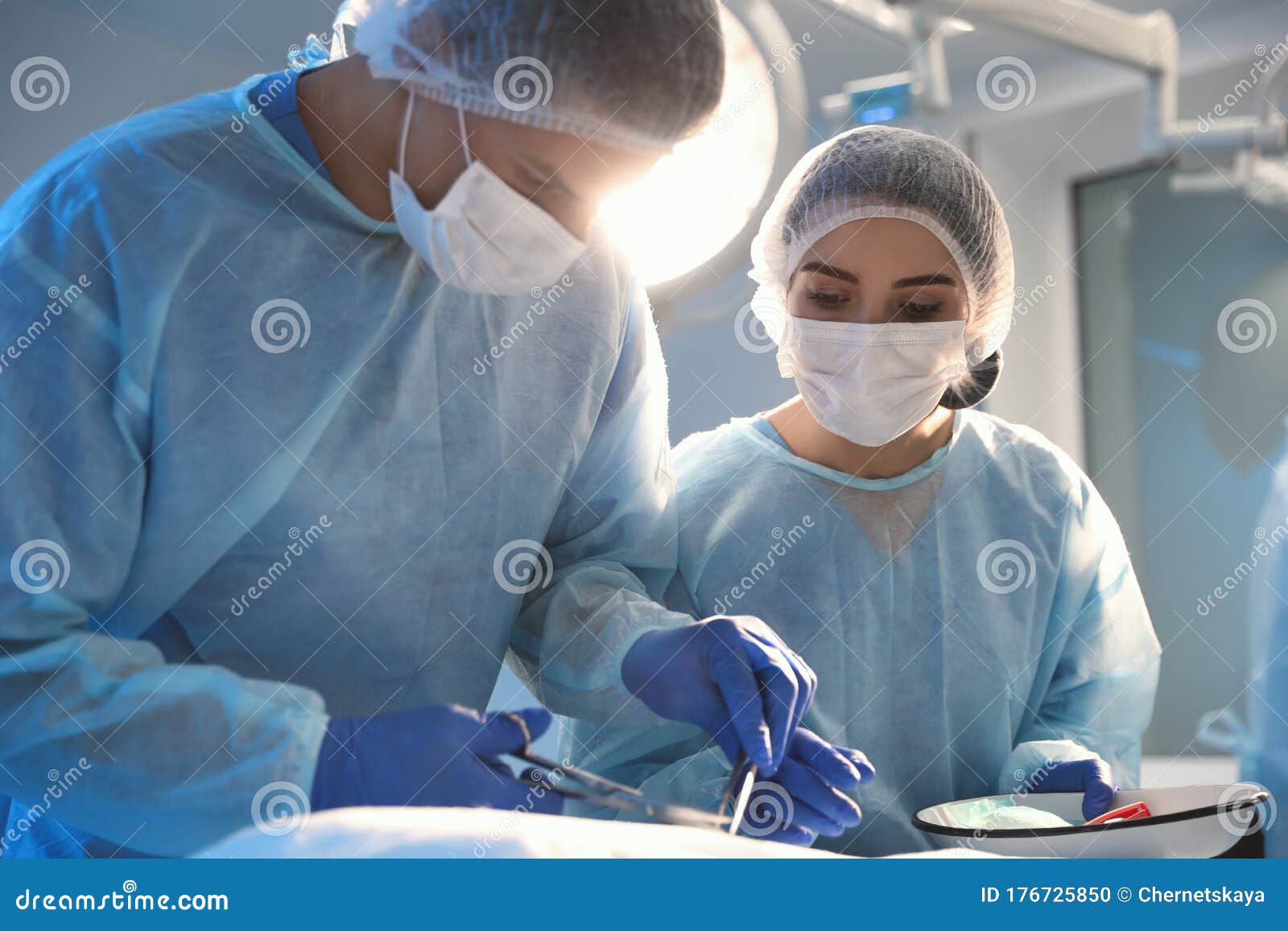 Team of Doctors Performing Operation in Surgery Room Stock Photo ...