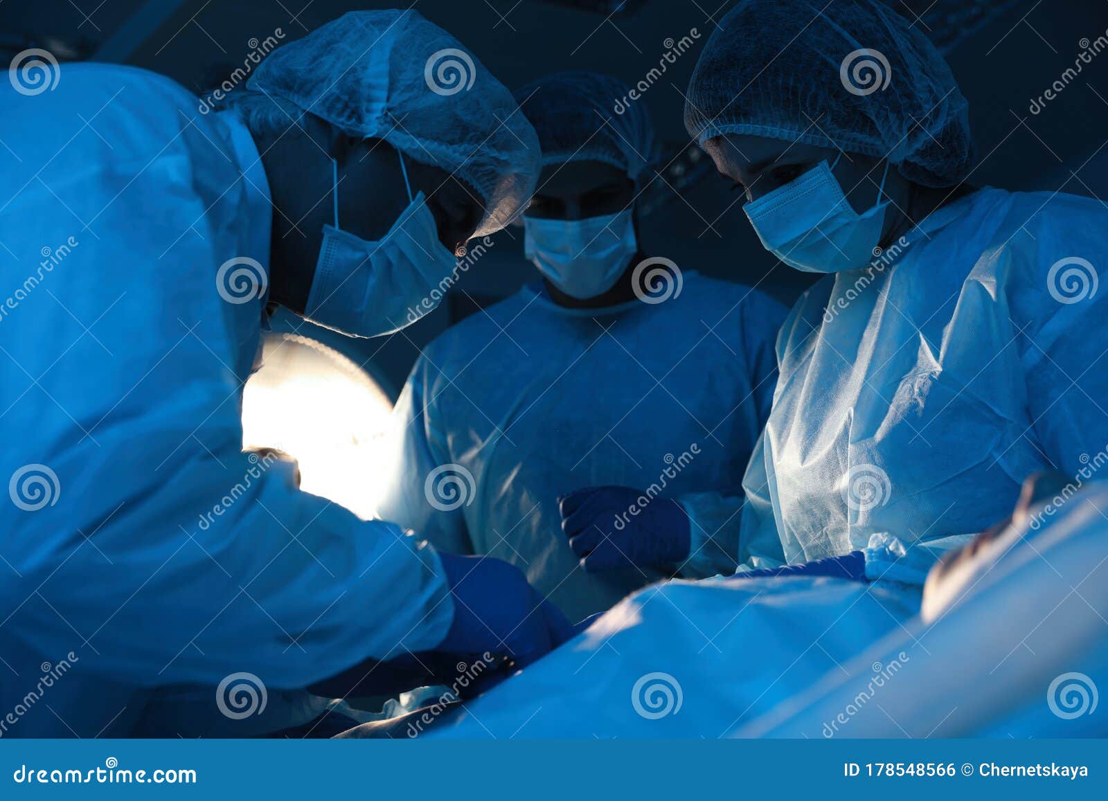 Team of Doctors Performing Operation in Surgery Room Stock Photo ...