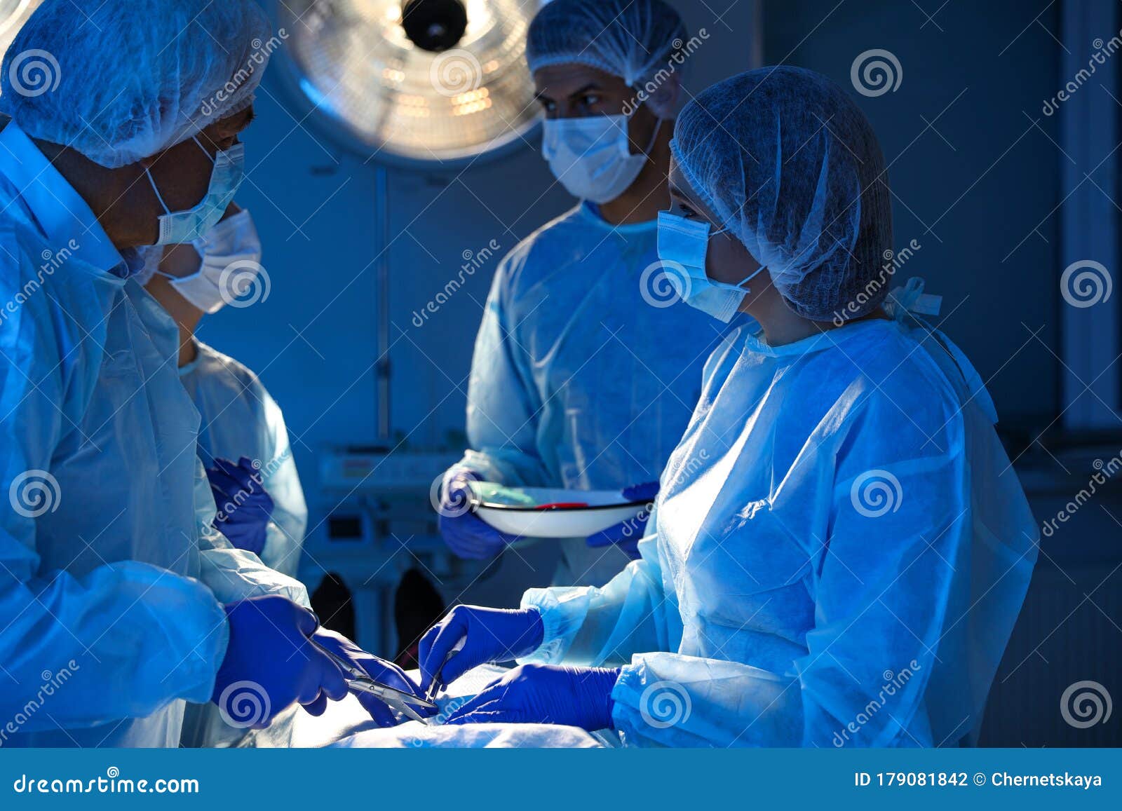 Team of Doctors Performing Operation in Surgery Room Stock Photo ...