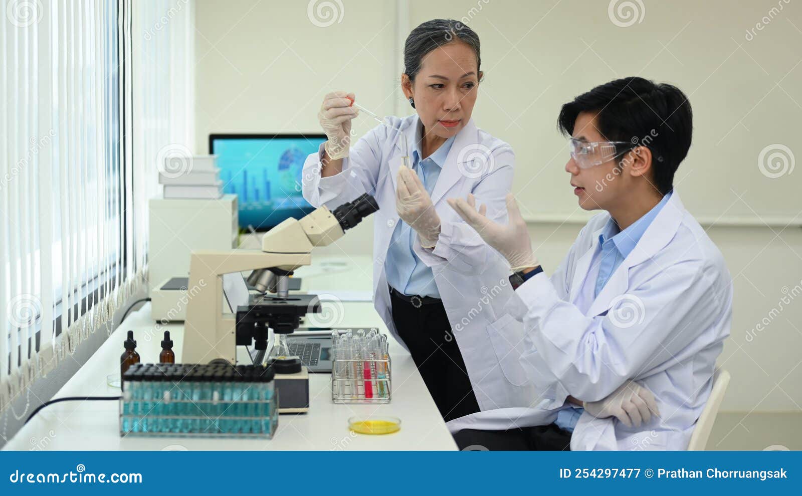 Team of Professional Scientists Talking, Working Together in Laboratory ...