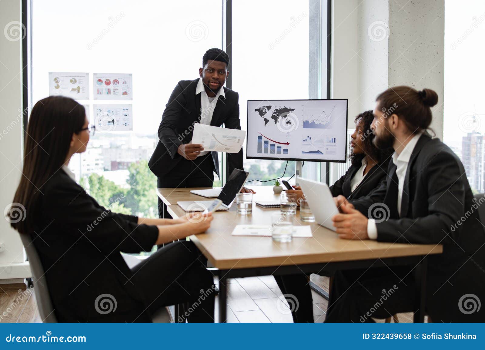 Business Meeting Presentation in Modern Office with Charts and Graphs ...