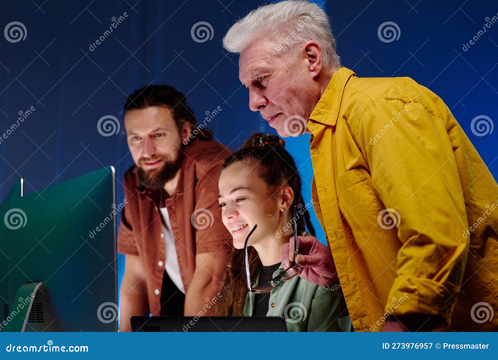 Team of Programmers Gathered in Front of Computer Screen in Dark Office ...