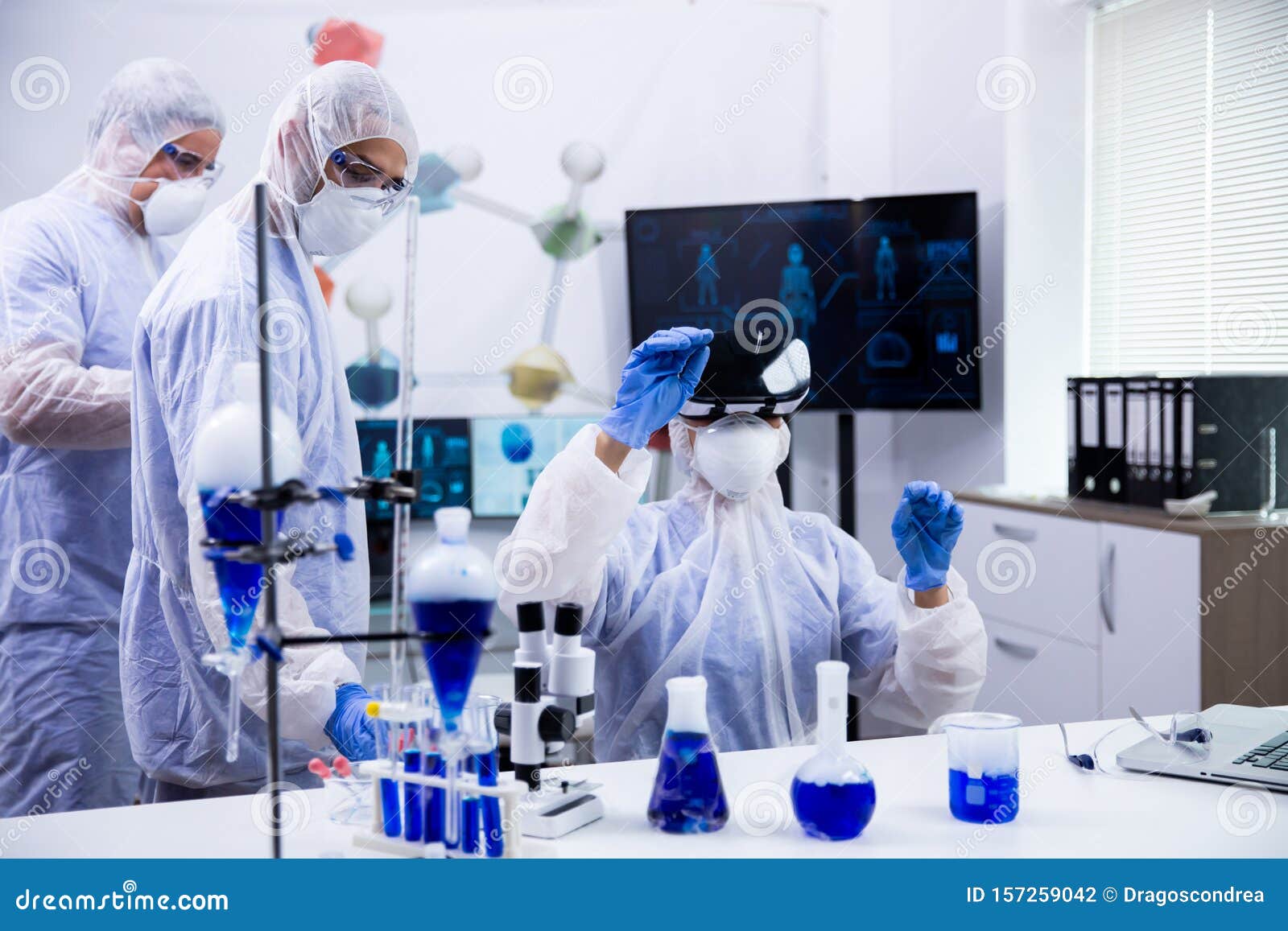Team of Scientist Using Virtual Reality Goggles for Scientific Research ...