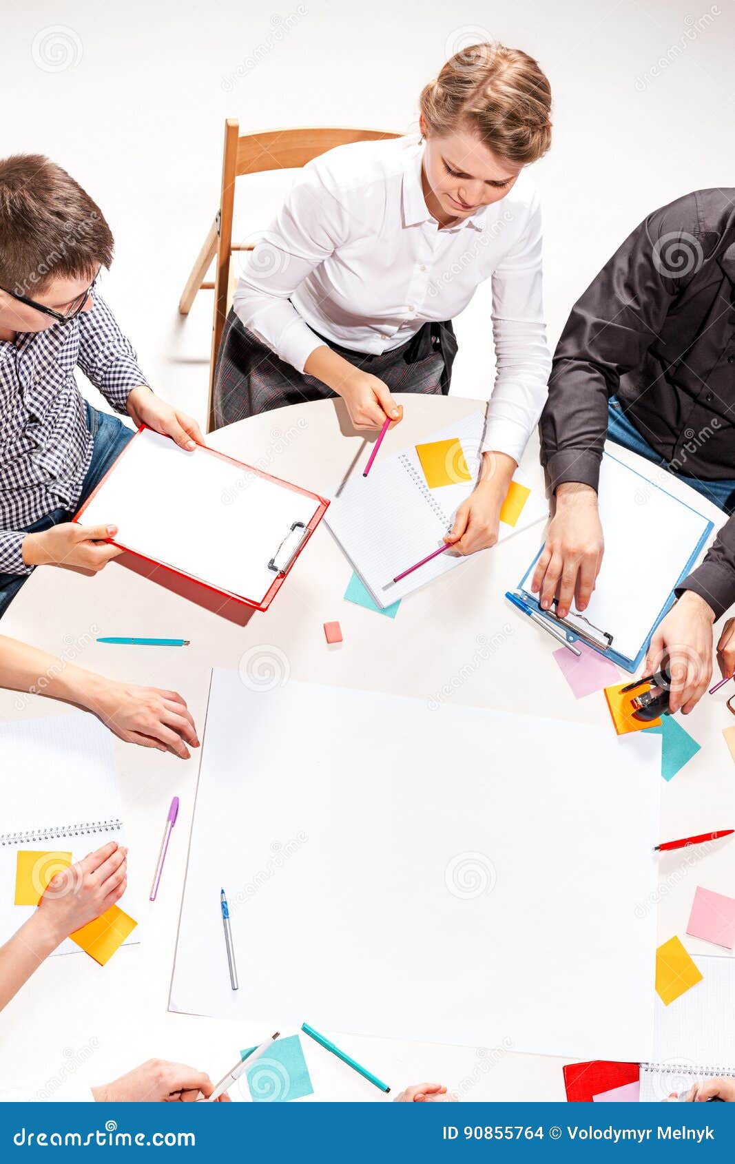 Team Sitting Behind Desk, Checking Reports, Talking. Stock Photo ...